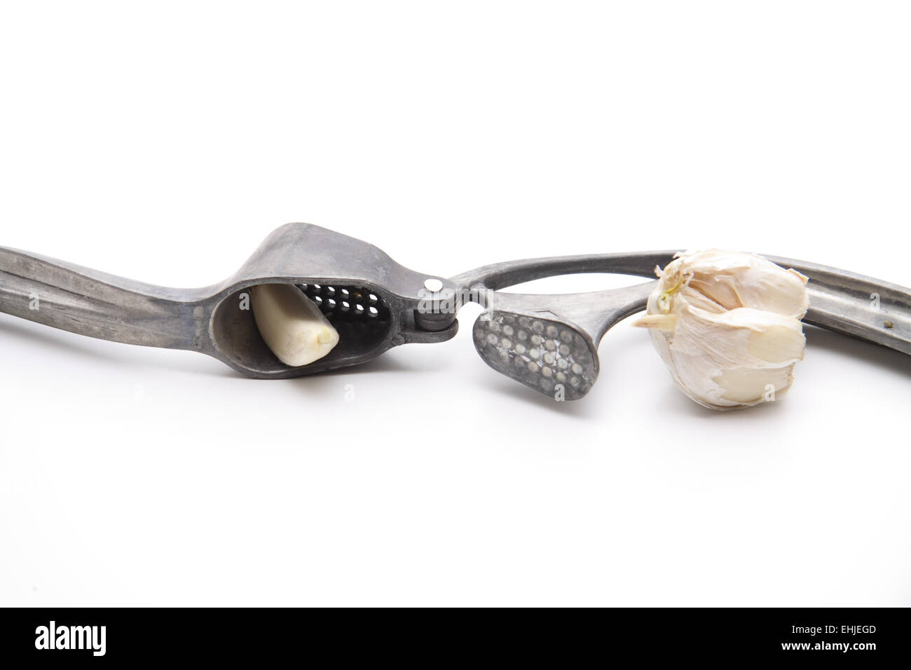 Garlic press with garlic Stock Photo - Alamy