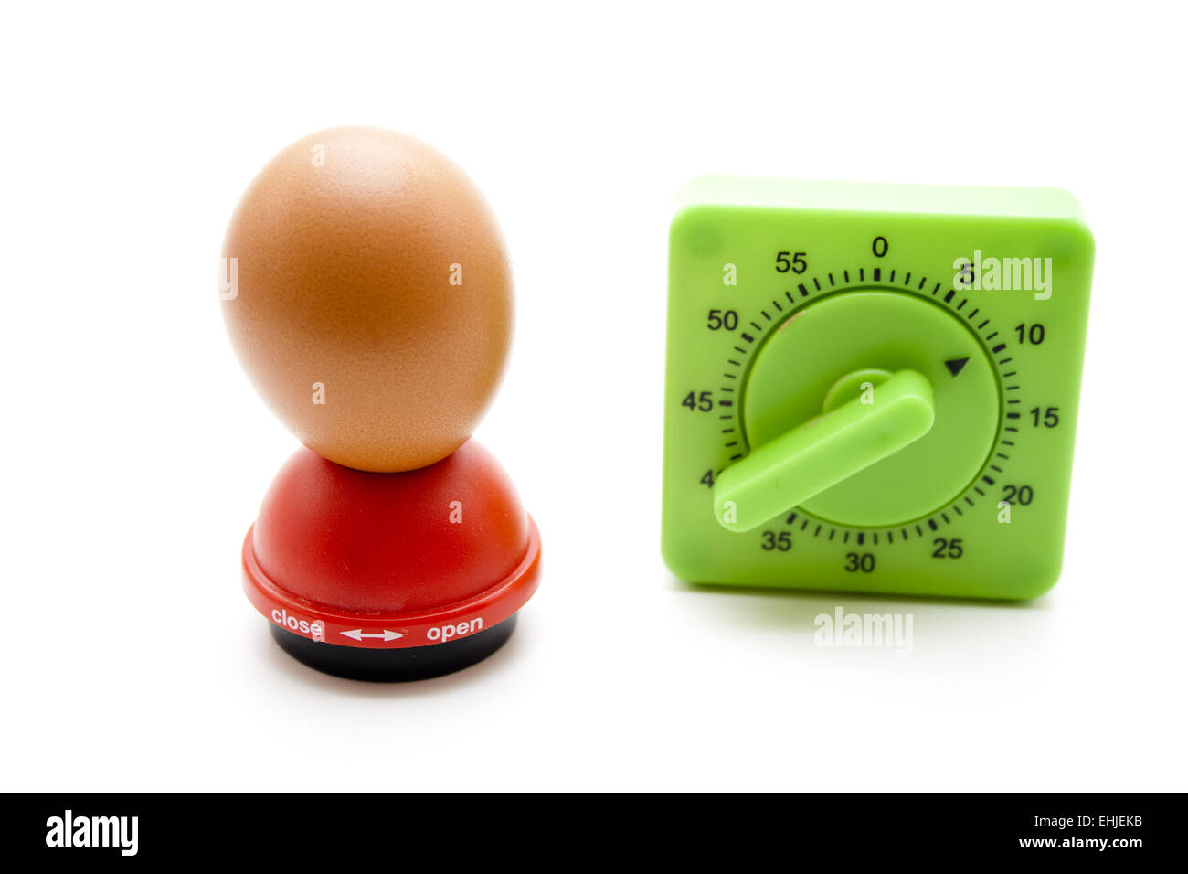 Time clock with egg Stock Photo - Alamy