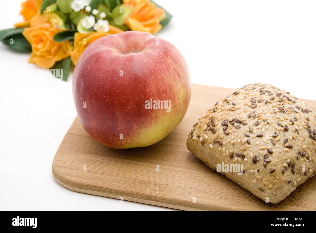 Red apple and wholemeal roll Stock Photo - Alamy