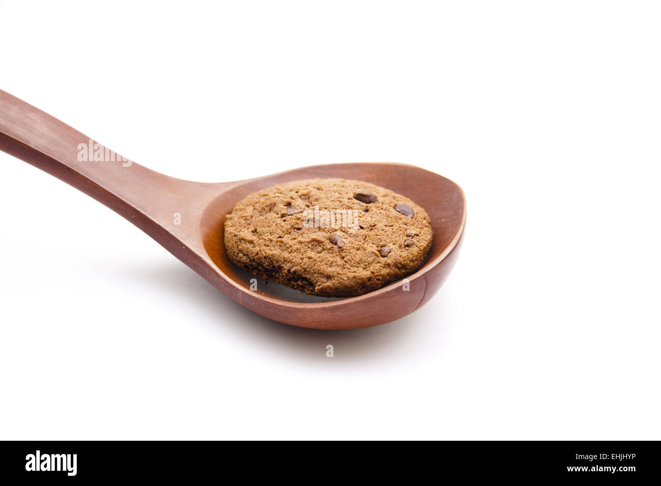 Cookie on wooden spoon Stock Photo - Alamy