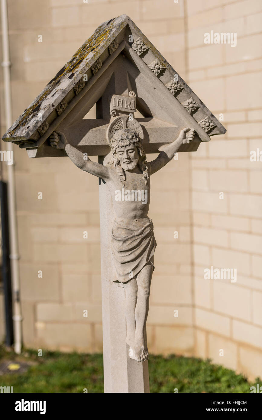 a depiction in stone of Jesus Christ on the cross on a gravestone in a cemetery Stock Photo - Alamy