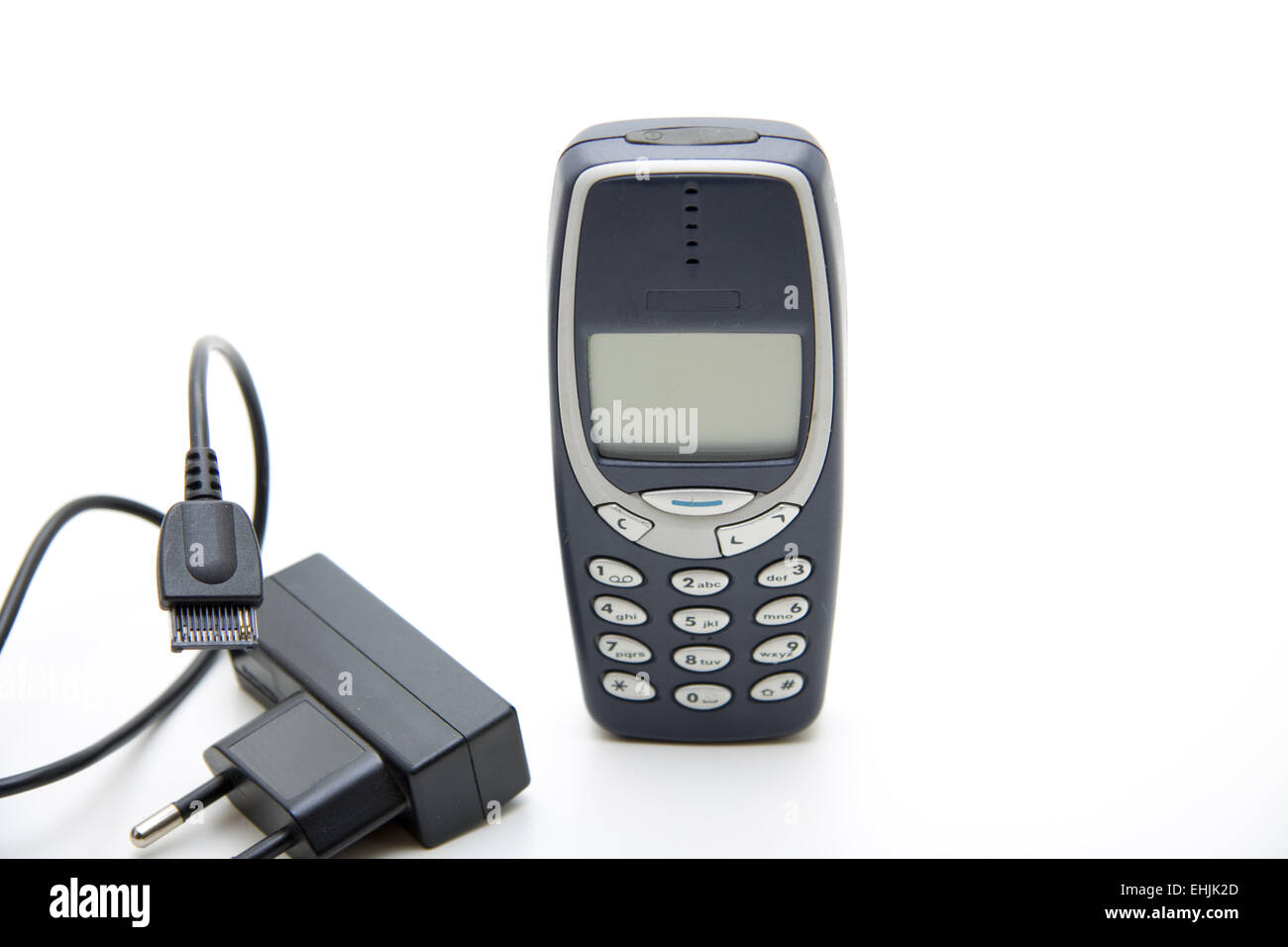 Mobile phone with loading cable Stock Photo - Alamy