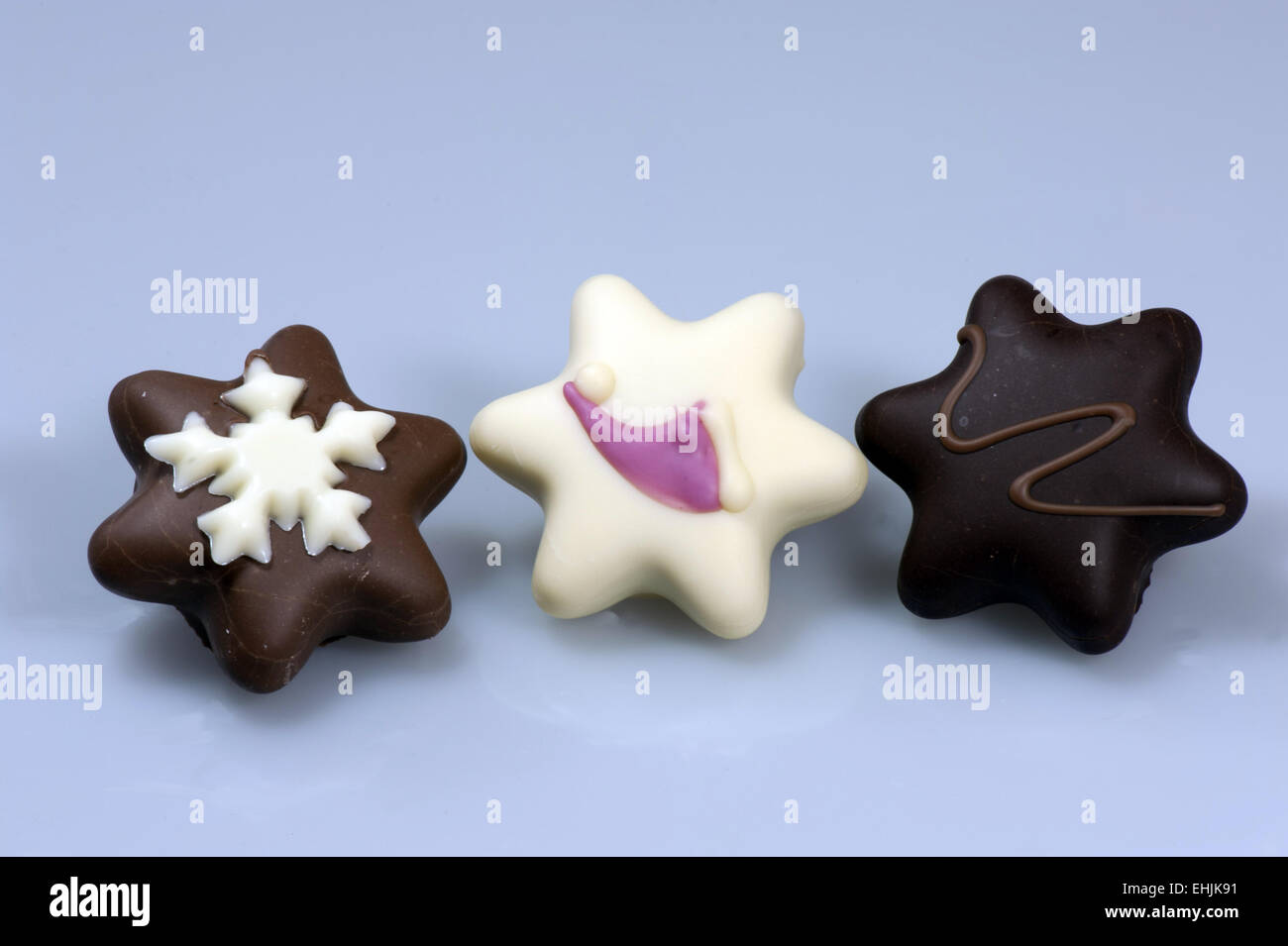 Three chocolate stars for Christmas Stock Photo - Alamy