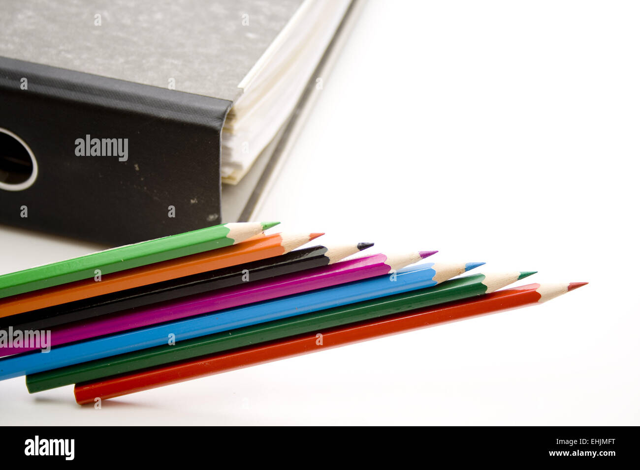 Colored pencils with folder Stock Photo - Alamy