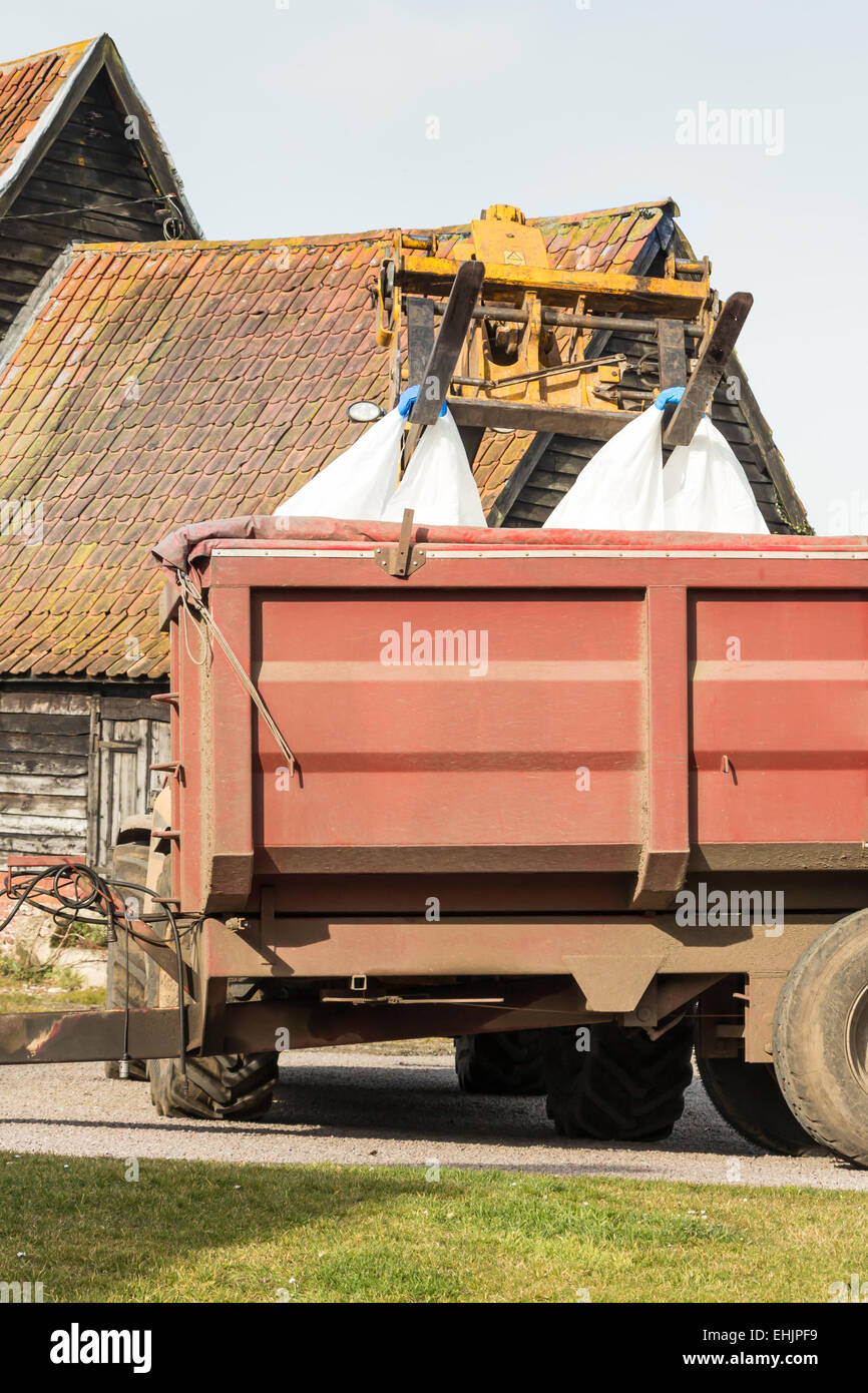 Tractors working in the farmyard loading fertilizer Stock Photo - Alamy