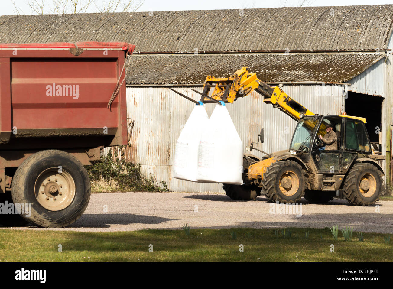 Tractors working in the farmyard loading fertilizer Stock Photo - Alamy