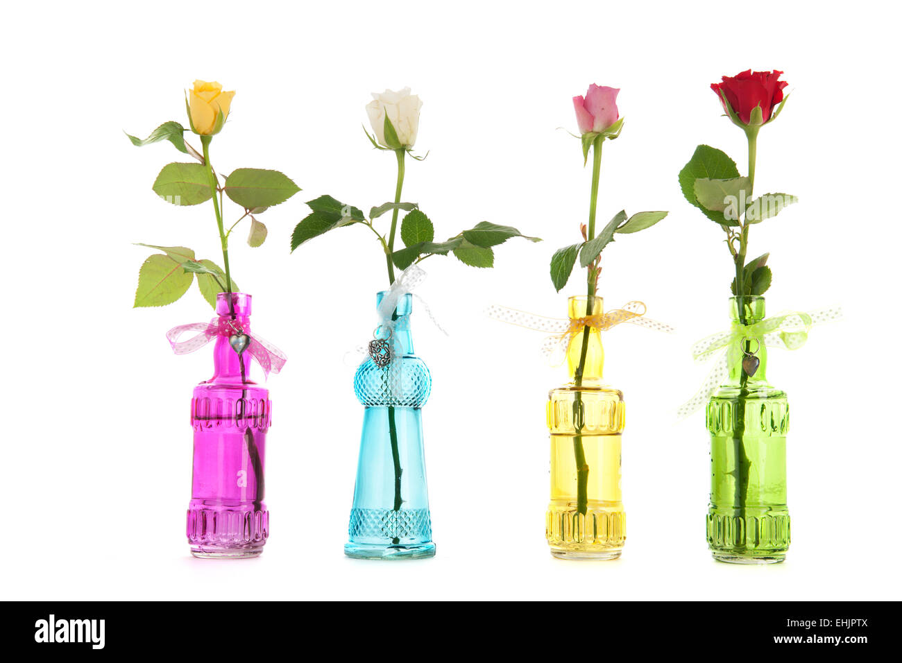 Colorful single roses in little glass vases Stock Photo - Alamy