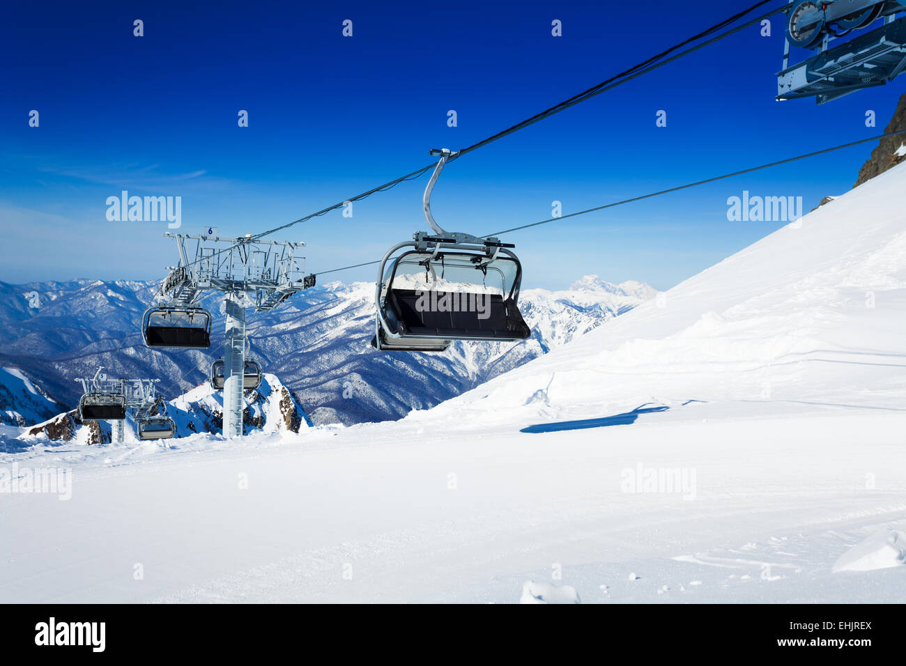 Ski chairlift over mountains on winter resort Stock Photo - Alamy