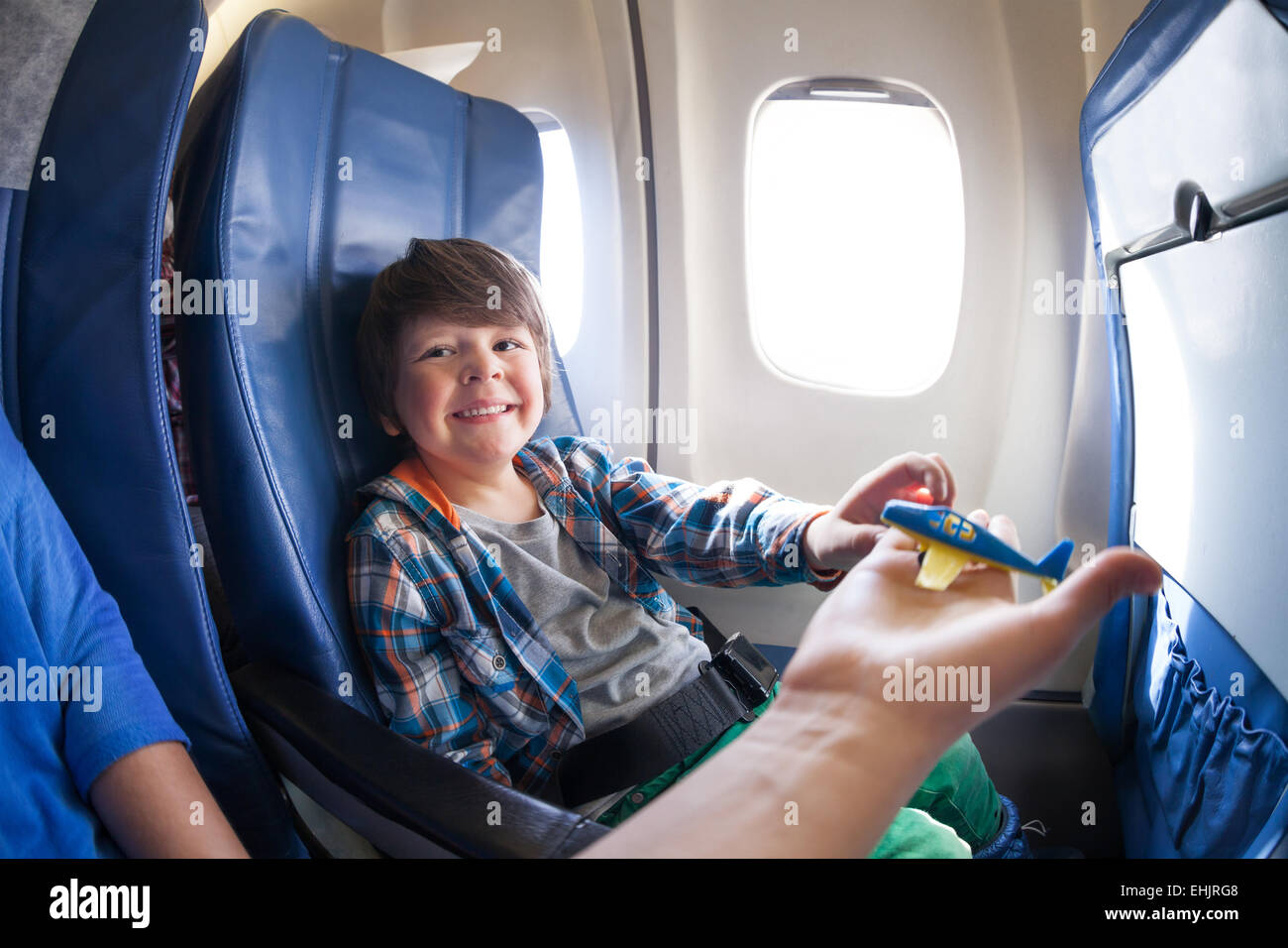 Laughing boy take toy plane, sit in jet airplane Stock Photo - Alamy