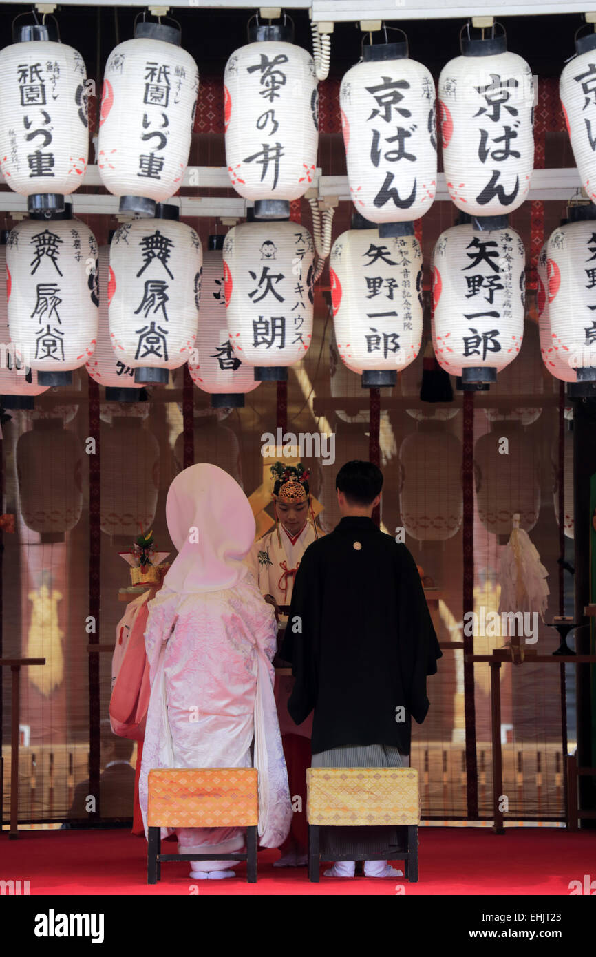 A bride and groom in traditional Japanese wedding kimono in a Shinto ...