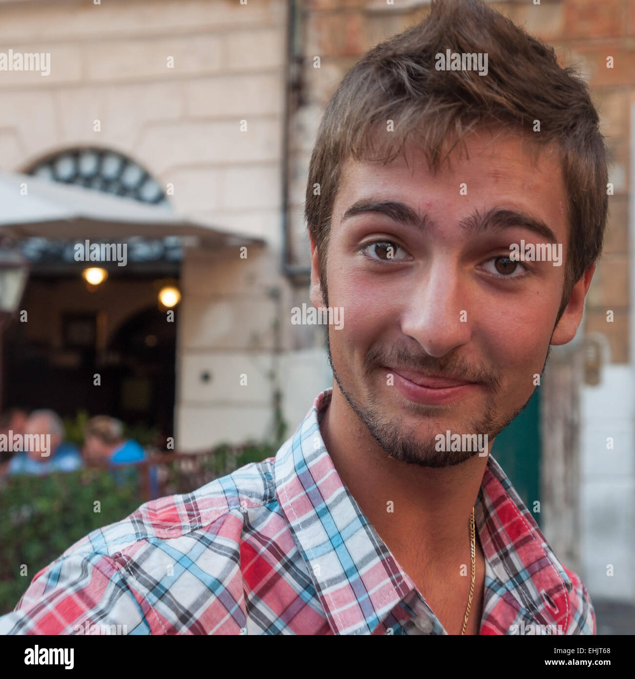 A boy with a funny smiling expression in italy Stock Photo - Alamy