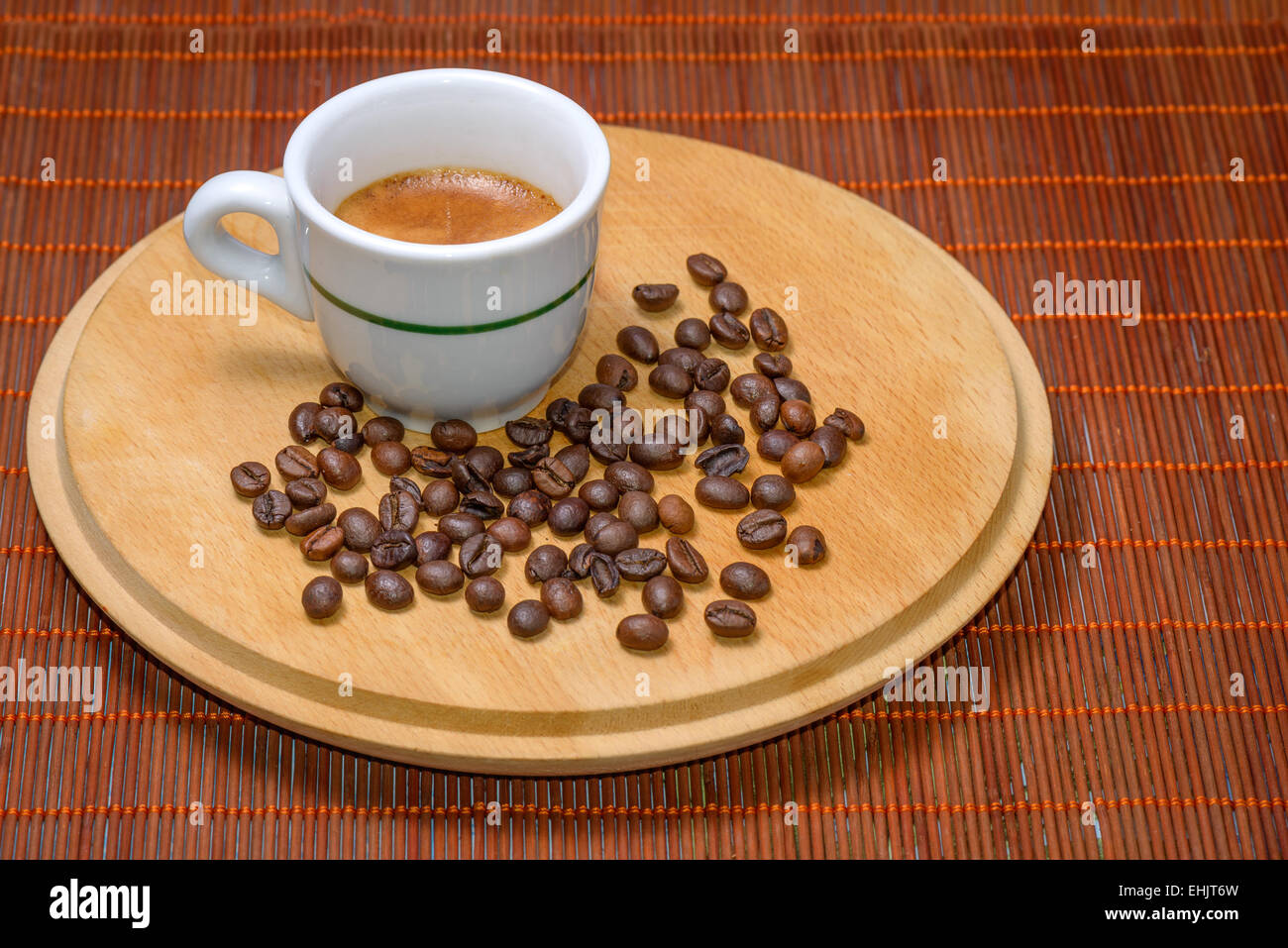 A cup of coffee on wood with seeds around Stock Photo - Alamy