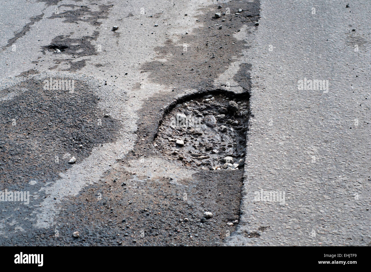 Big pothole in road after spring thaw Stock Photo - Alamy