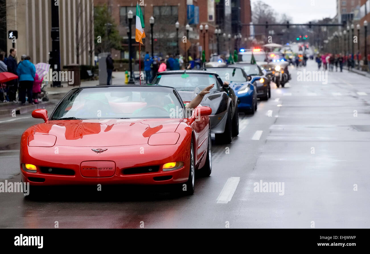 Drivers wave from a line of Chevrolet Corvette sports cars as they ...