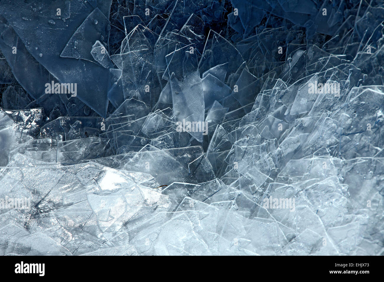 Cracked blue ice on frozen water Stock Photo - Alamy