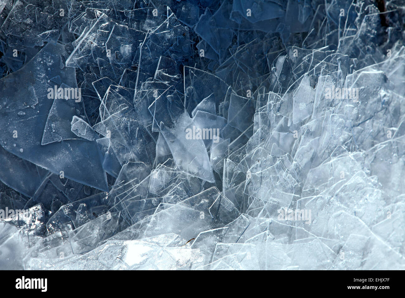 Cracked blue ice on frozen water Stock Photo - Alamy