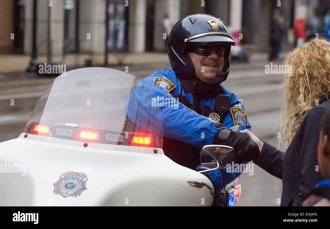 An unidentified Lexington Police motorcycle officer shakes hands with a ...