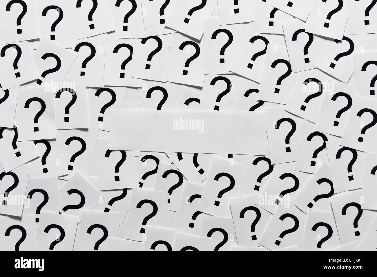 Put your own question on the label. Many question marks on paper ...