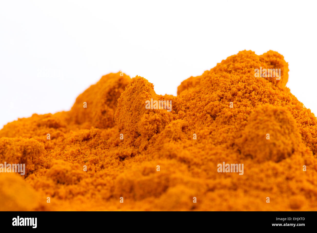 Organic and raw curcumin / turmeric spice pile on white background. Can ...