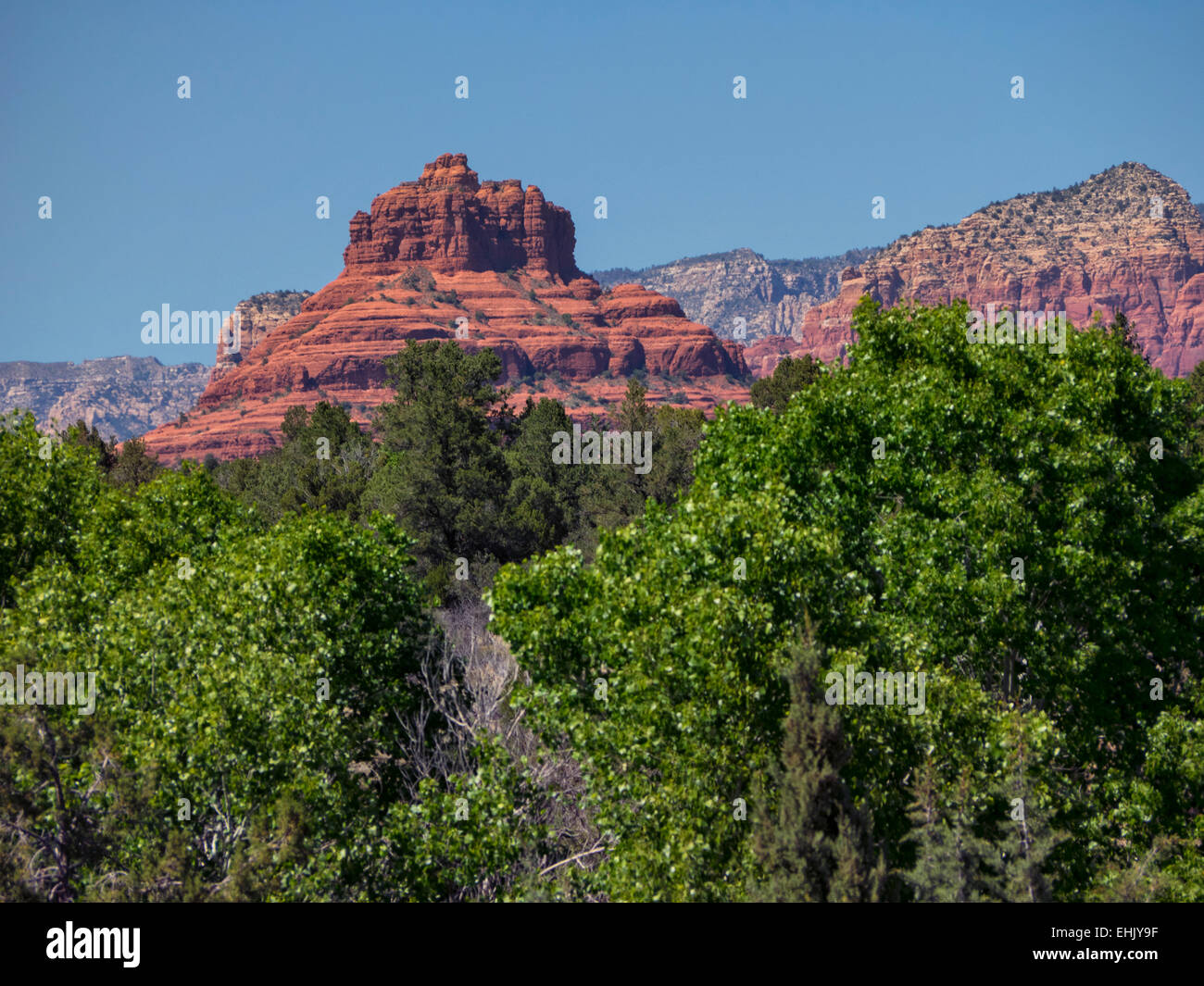 Sweeping view of red rock buttes and trees with focus on Bell Rock ...