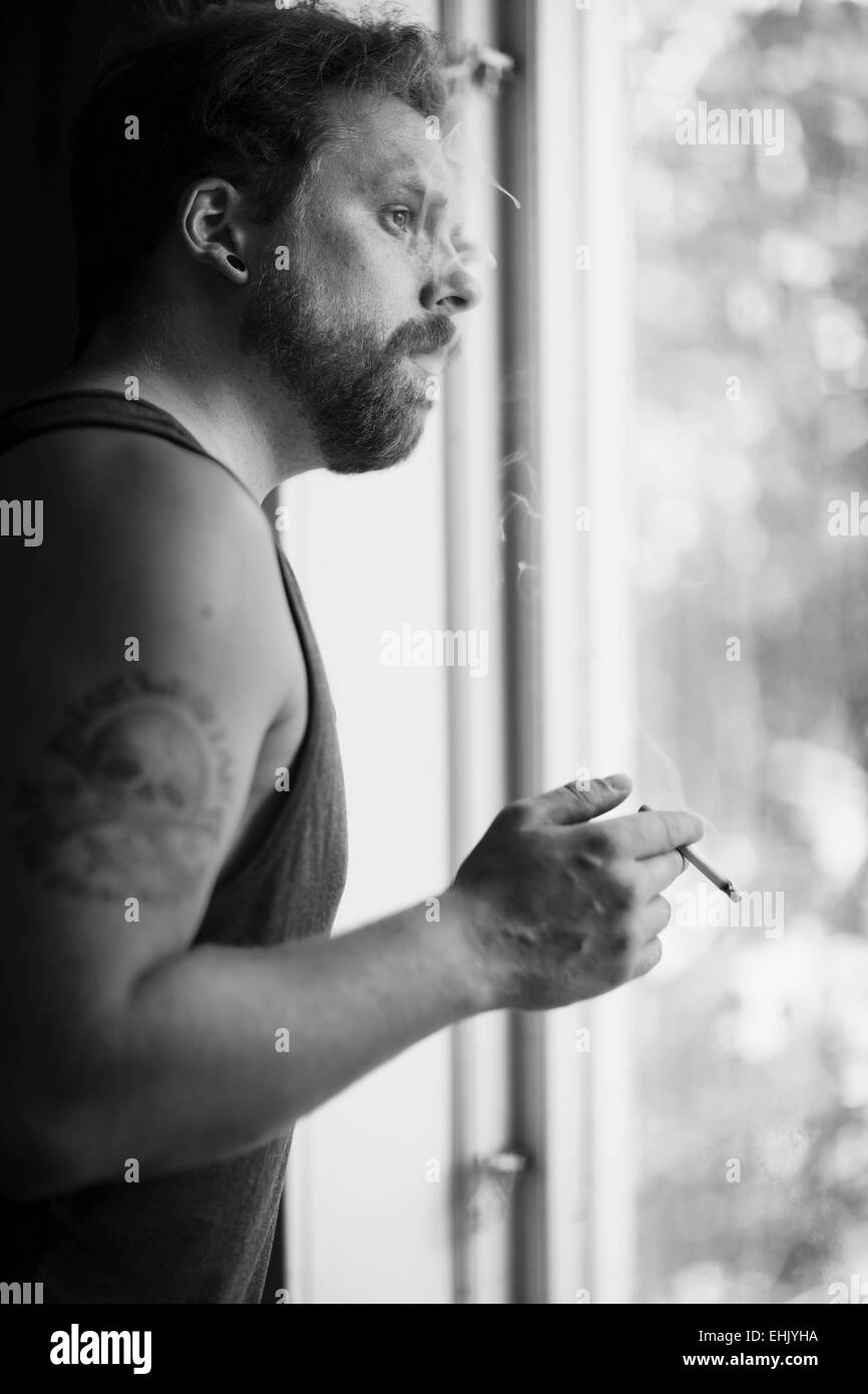 Punk rocker standing by window Black and White Stock Photos & Images ...