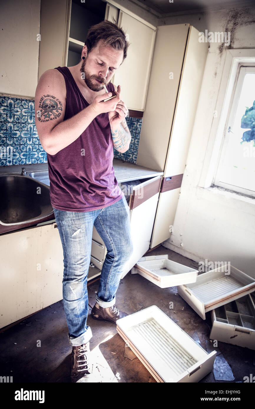 A young and exhausted redneck / rocker with hangover Stock Photo - Alamy