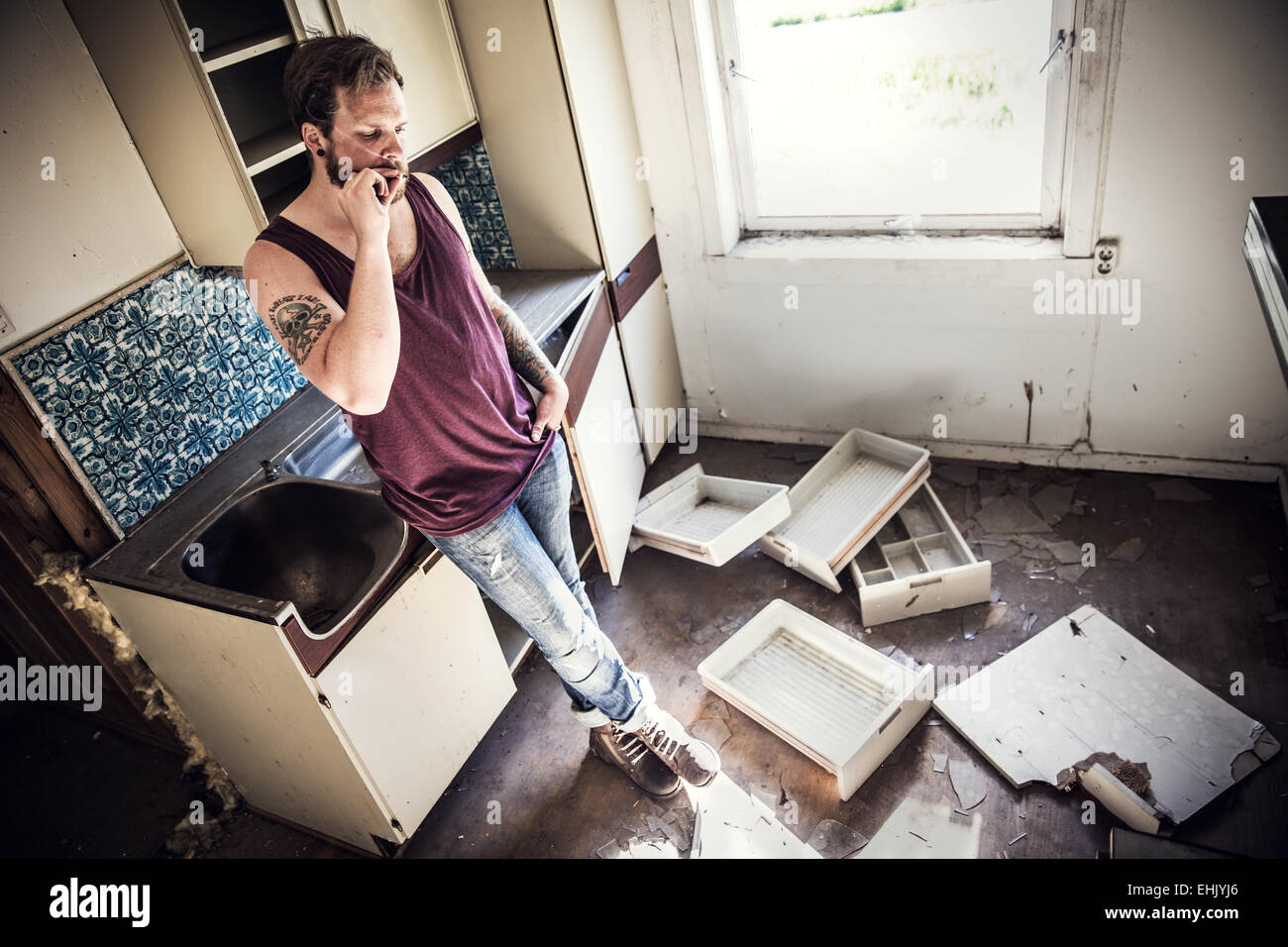 A young and exhausted redneck / rocker with hangover Stock Photo - Alamy