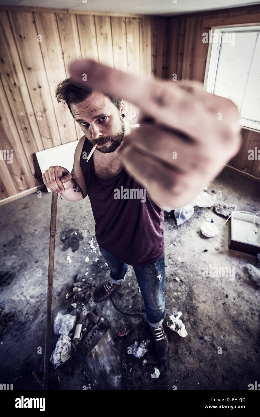 A young man and redneck / punk rocker gives finger Stock Photo - Alamy