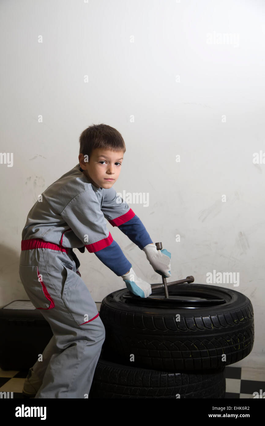 Boy in the auto repair shop Stock Photo - Alamy