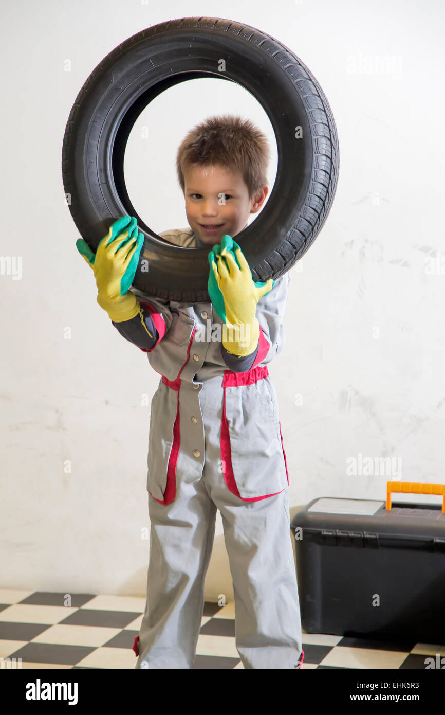 Boy in the auto repair shop Stock Photo - Alamy