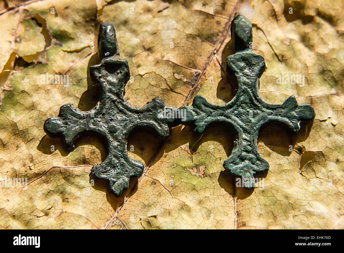 two medieval copper Christian crosses in a strong patina against dry ...