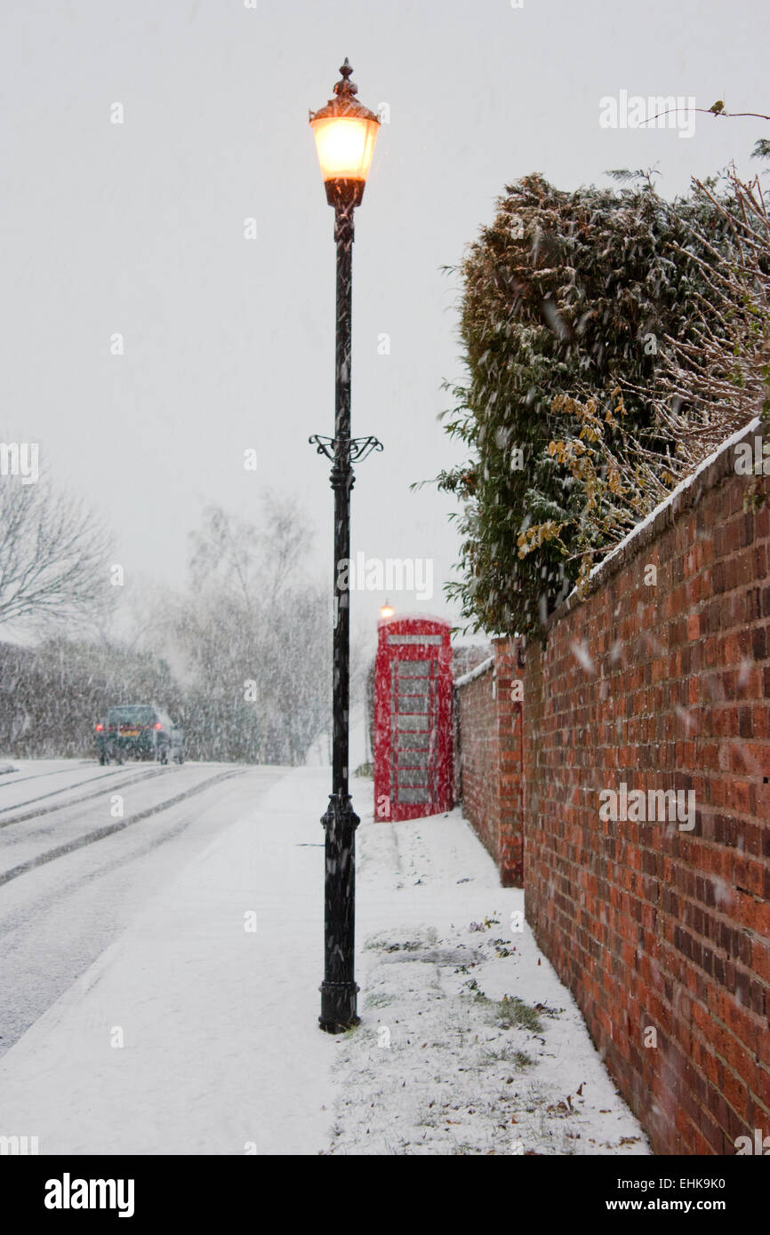 An old red telephone box and an old fashioned lamp post, on a village ...