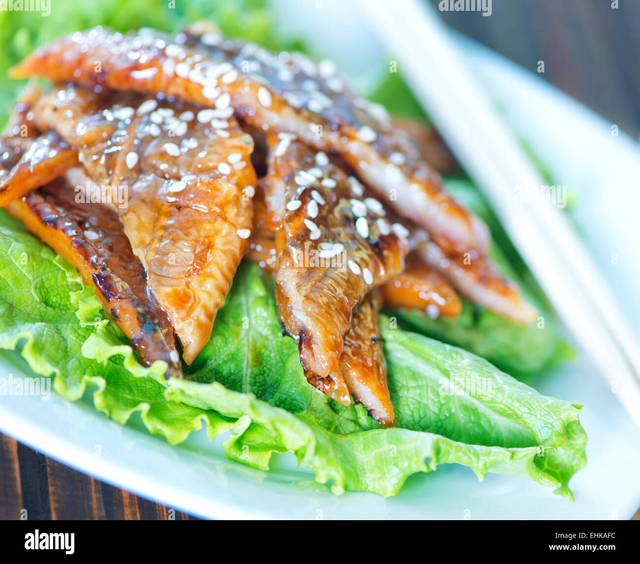 salad with fried eel and sauce on the plate Stock Photo - Alamy