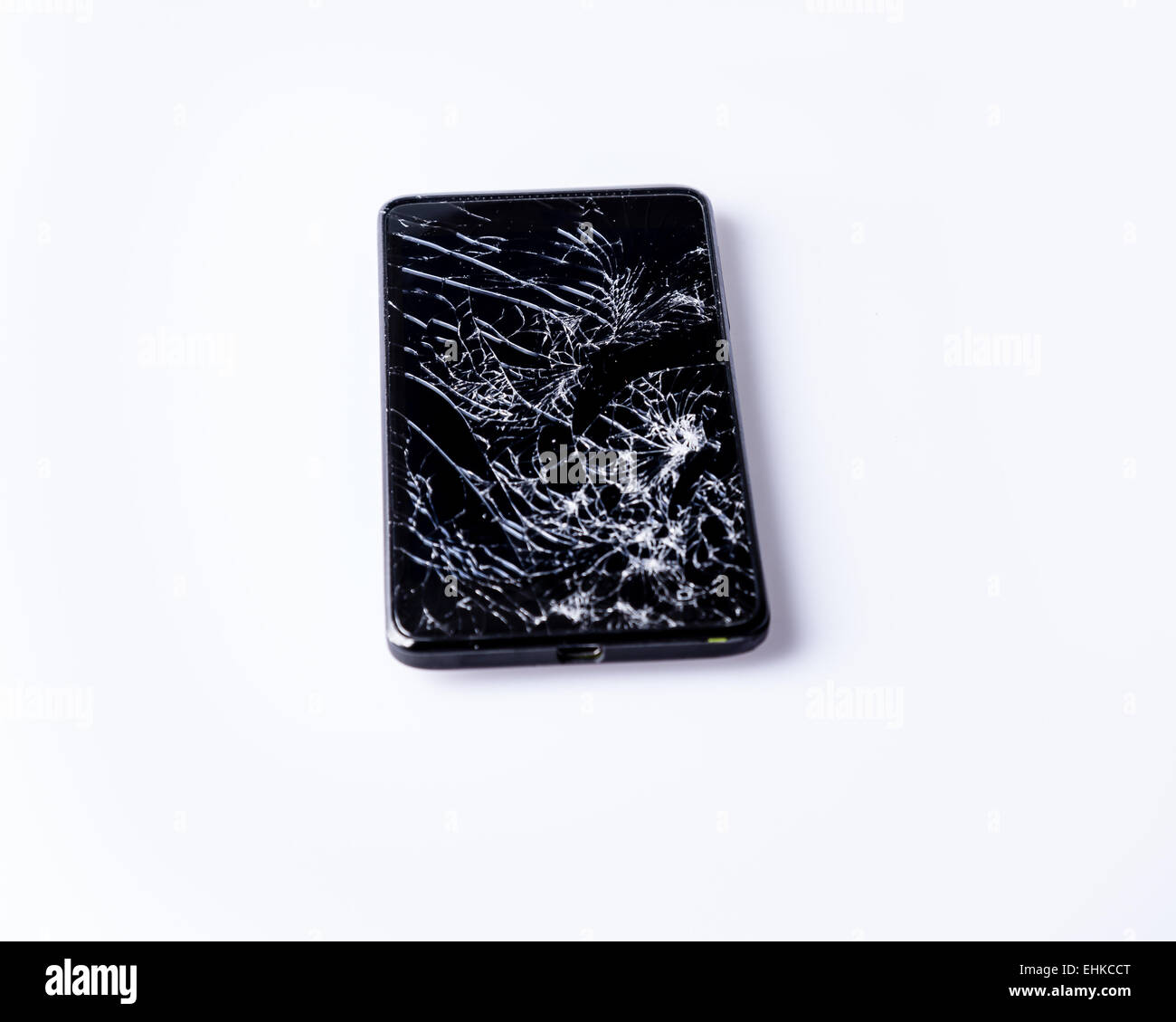 Closeup of mobile smartphone with broken screen on white with copy ...
