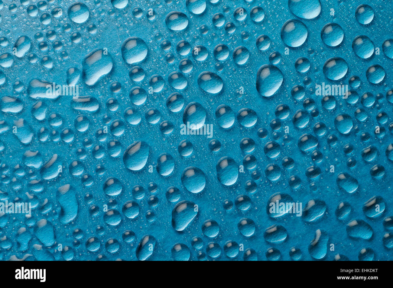 Droplets on blue background Stock Photo - Alamy