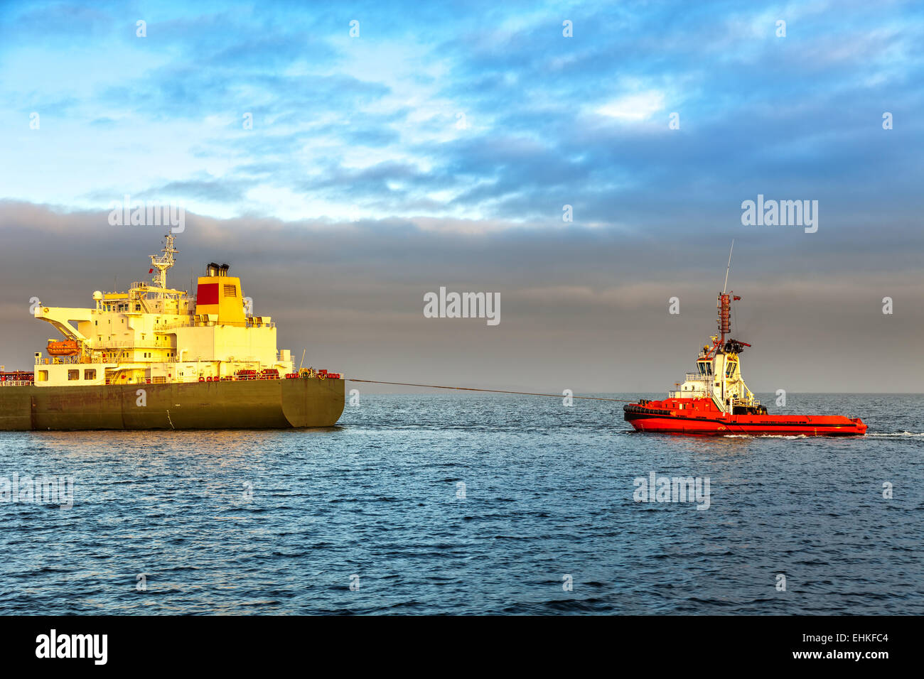 Tugboat pulling the tanker at sea in the morning Stock Photo - Alamy