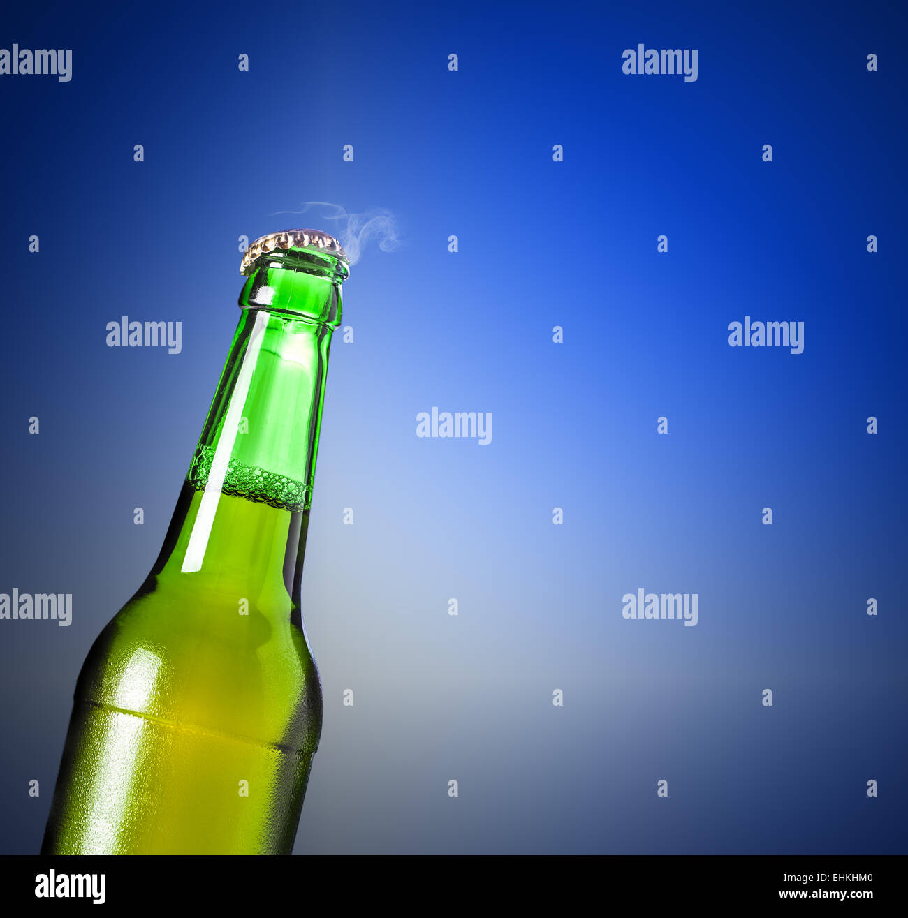 lager beer in bottle on a blue background Stock Photo - Alamy