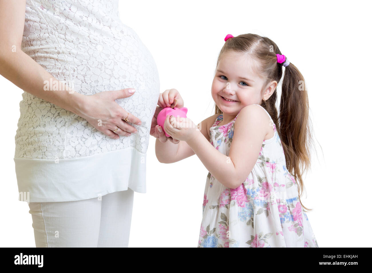 Pregnant mother and kid putting coins into piggy bank Stock Photo - Alamy