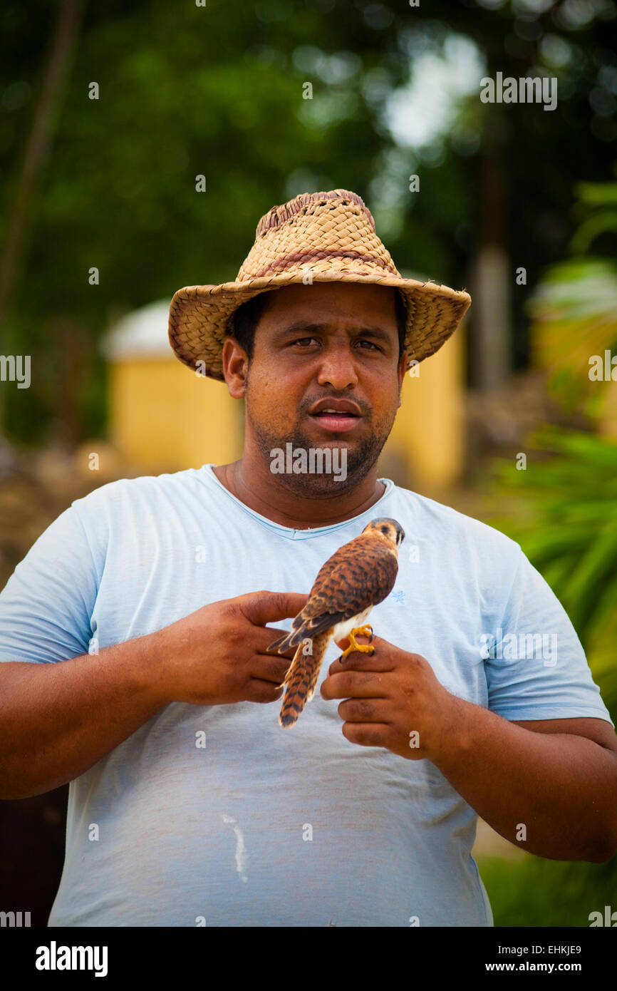 A man with a bird in Trinidad, Cuba Stock Photo - Alamy