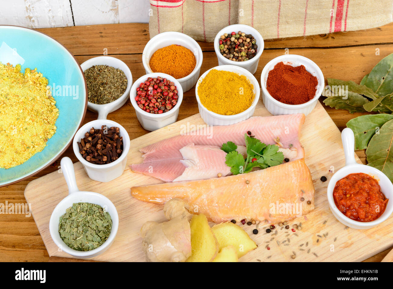 fish fillets with several spices on wooden table Stock Photo - Alamy