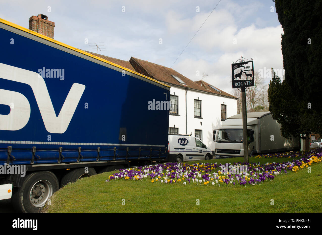 large lorries and van winding there way through narrow road around ...