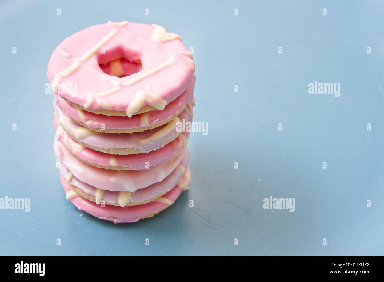 Stack of pink cookies on a blue surface Stock Photo - Alamy