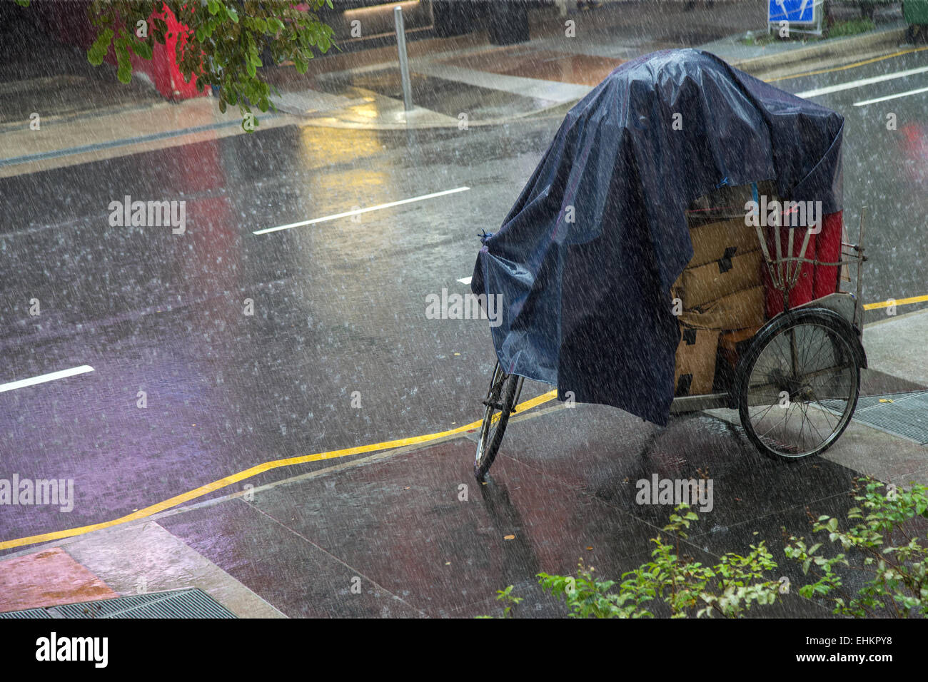 loaded tricycle on the street in the rain Singapore Stock Photo - Alamy