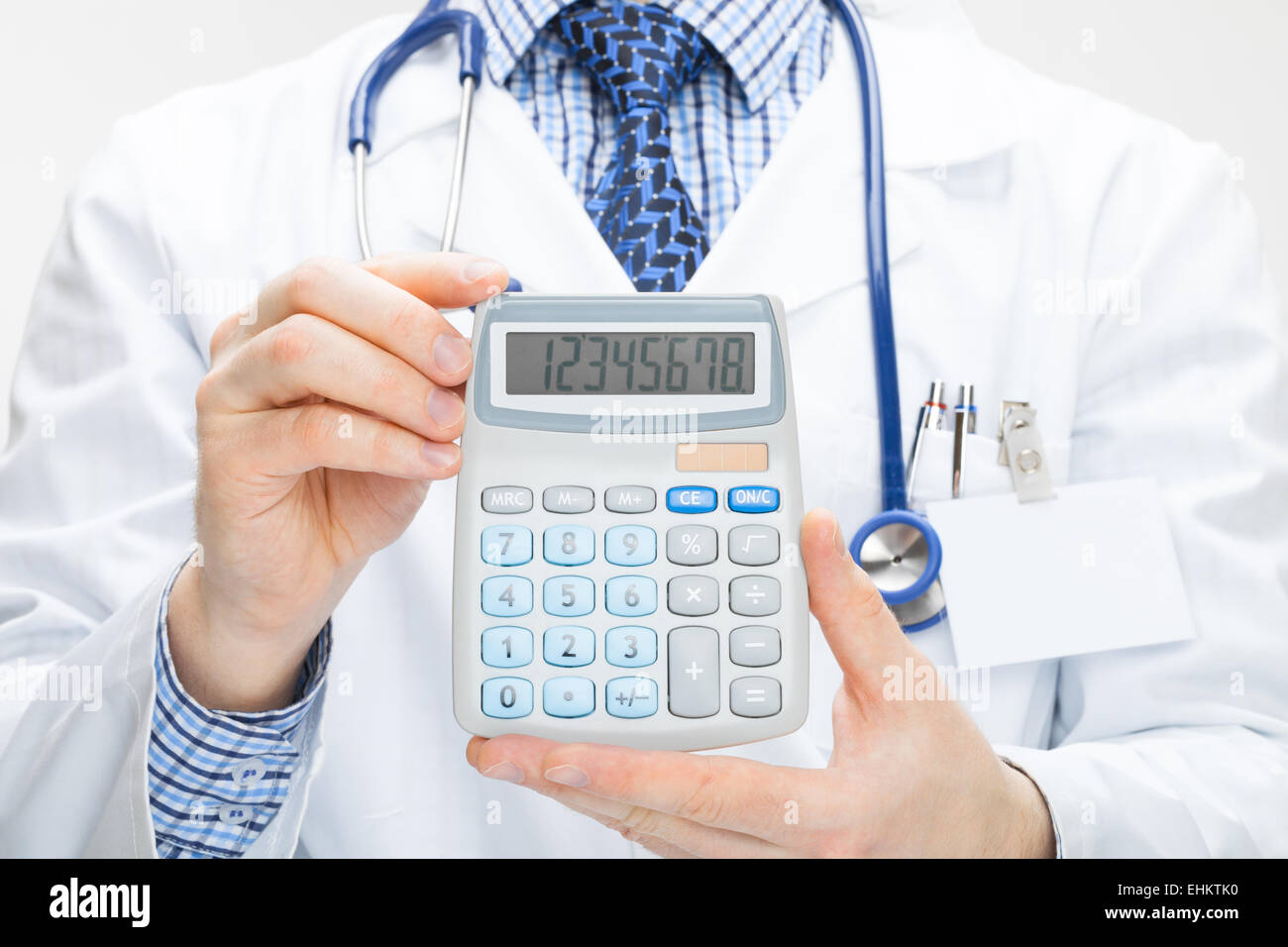 Doctor holding calculator in hands - health care concept - studio shot ...