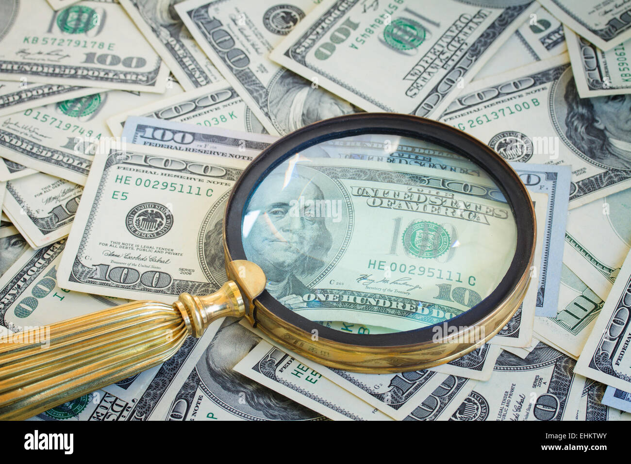 money under manifying glass Stock Photo - Alamy