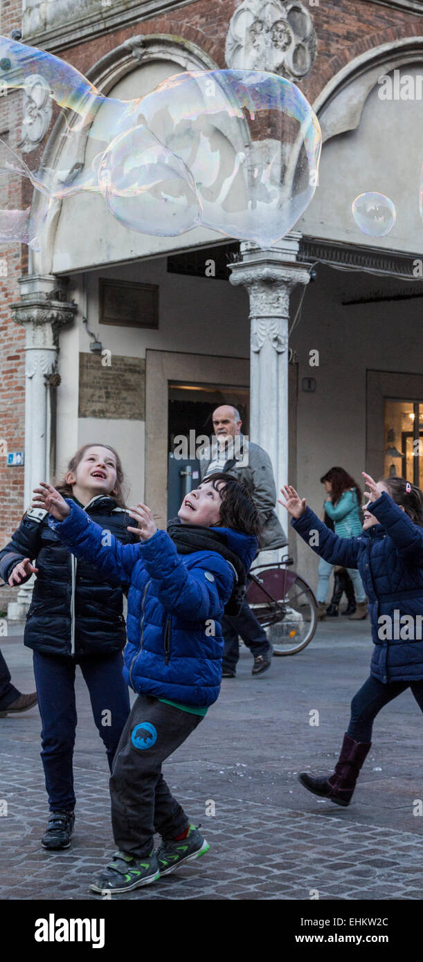 children playing wtih giant bubbles, Ferrara, Italy Stock Photo - Alamy