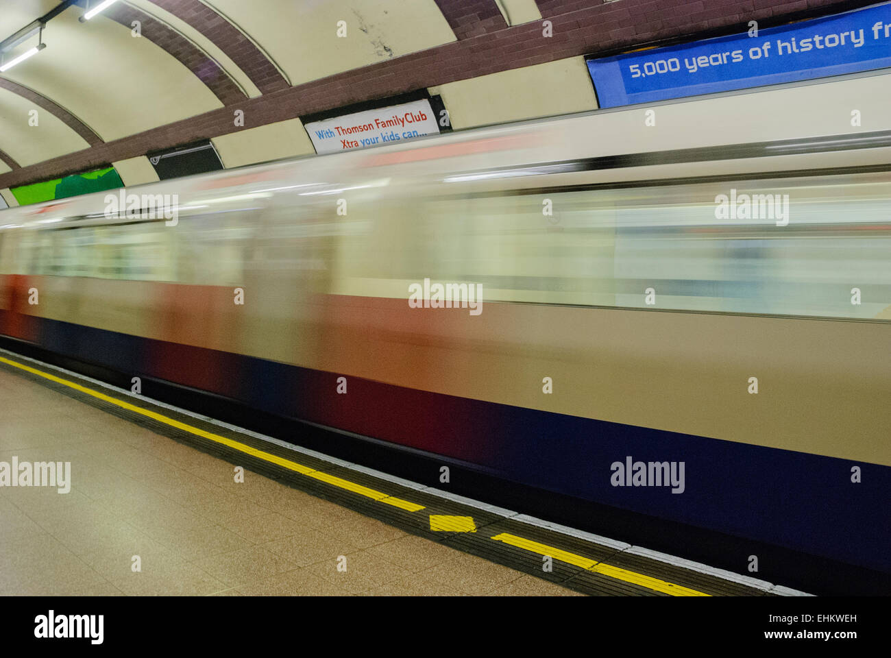 Train speeds through a London Underground tube station Stock Photo - Alamy