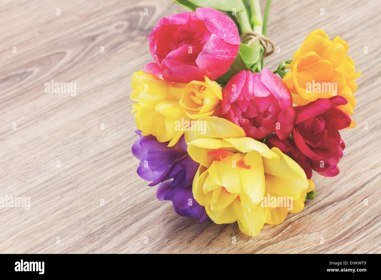 posy of spring flowers on wooden table Stock Photo - Alamy