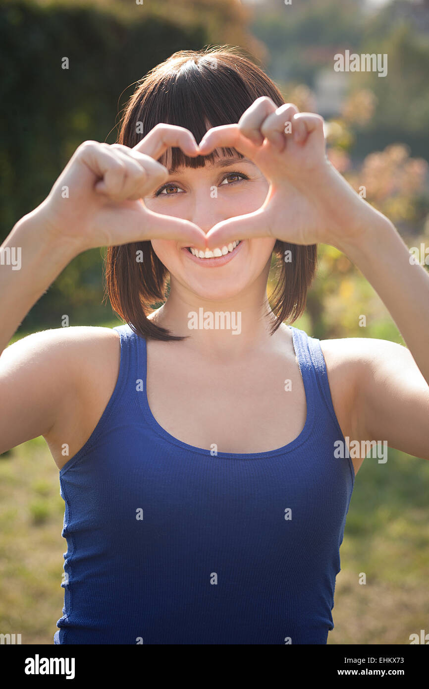Beautiful woman show love sign Stock Photo - Alamy
