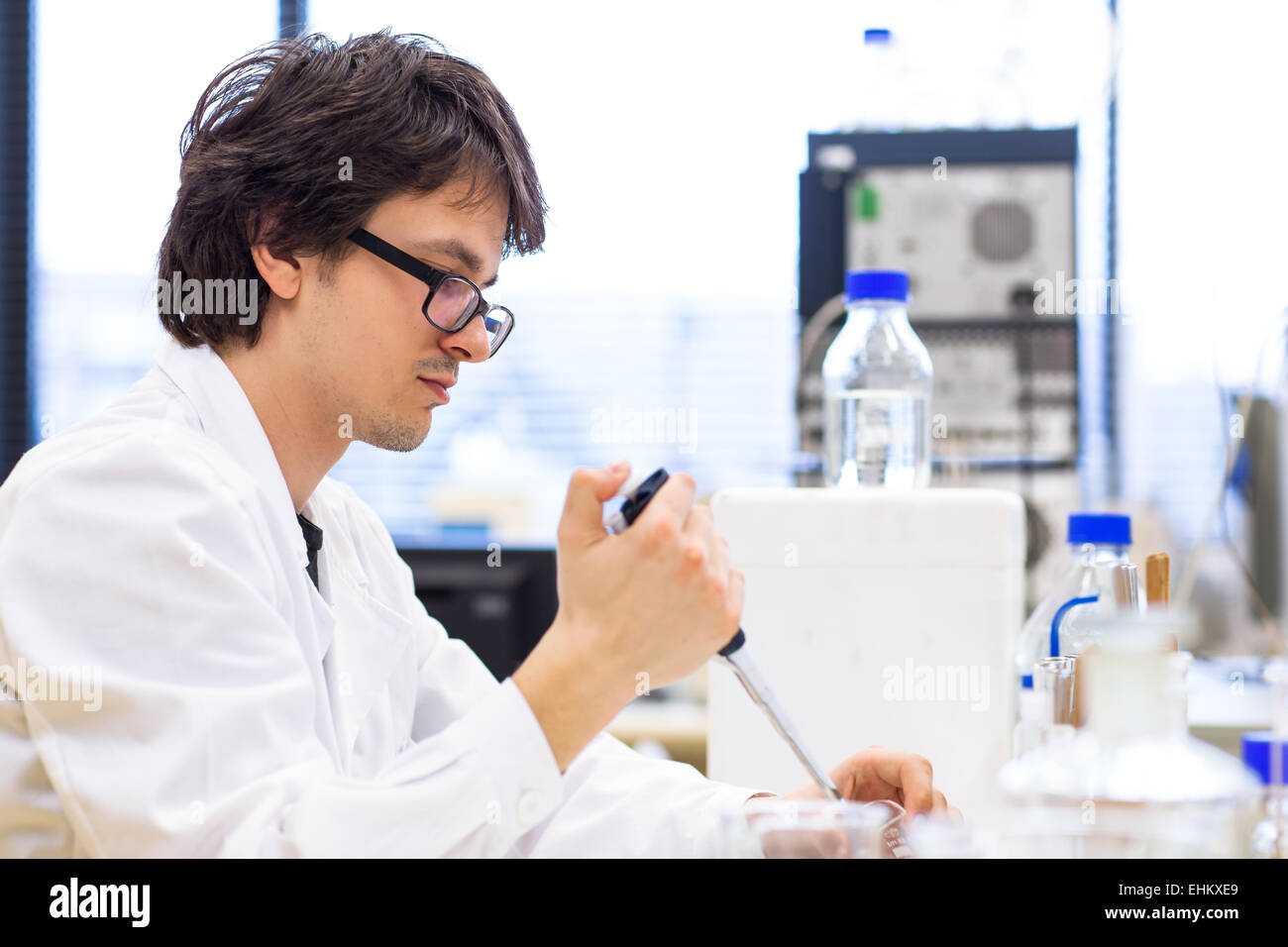 Male researcher carrying out scientific research in a lab (shallow DOF ...